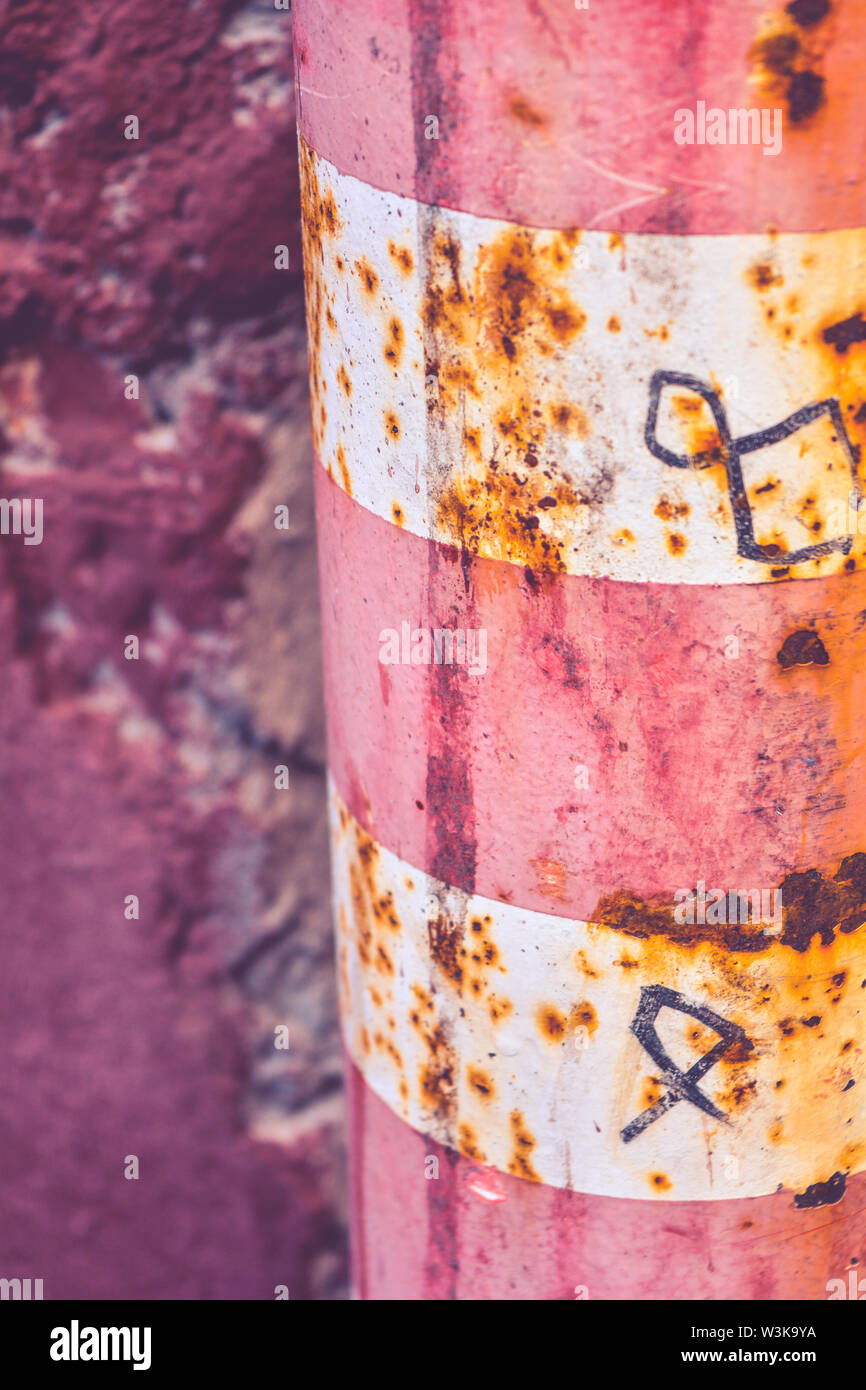 Old rustic Bollard or Traffic pole. Sign for cars with white and red ...
