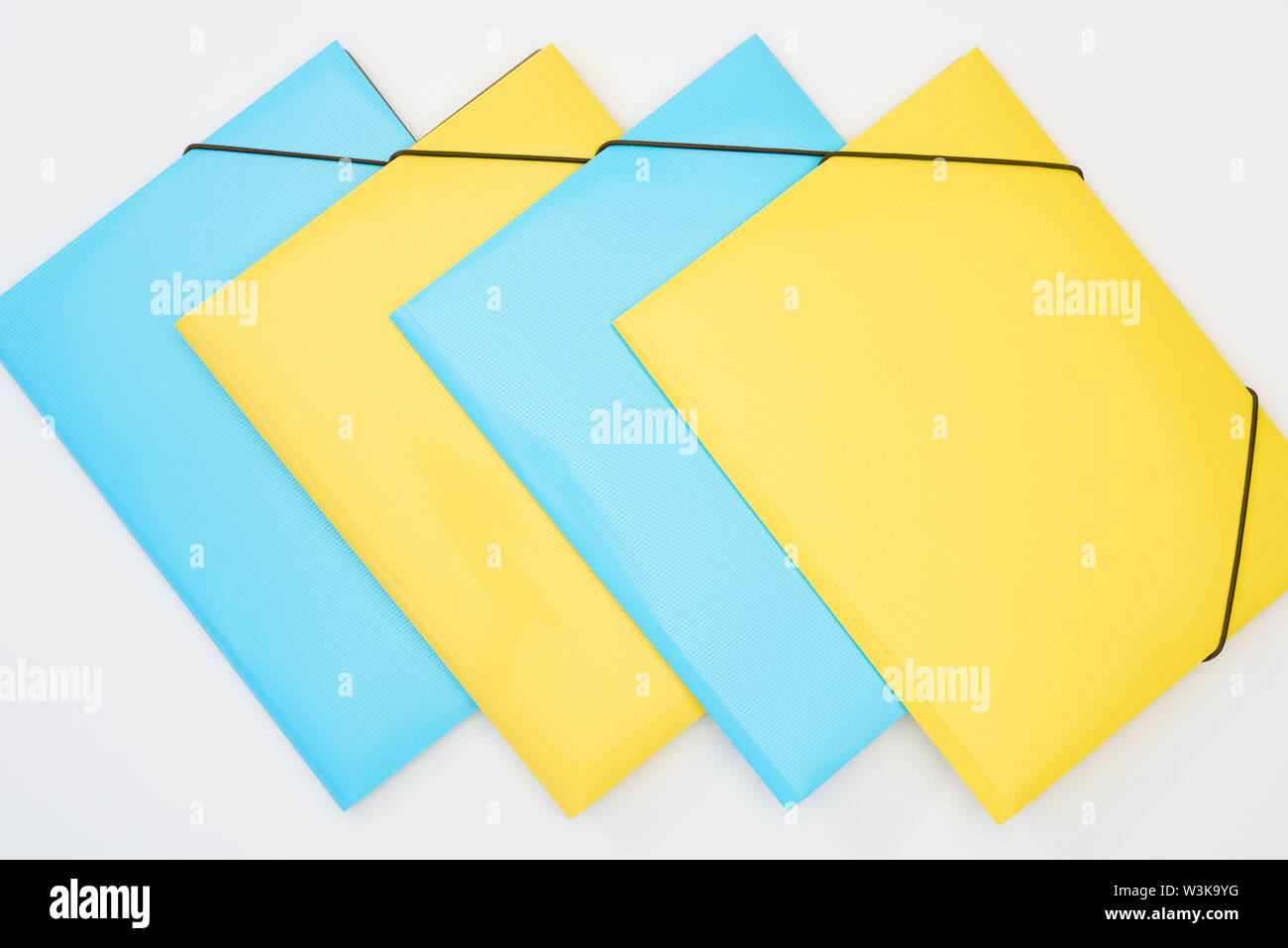 flat lay of yellow and blue folders on white background Stock Photo - Alamy