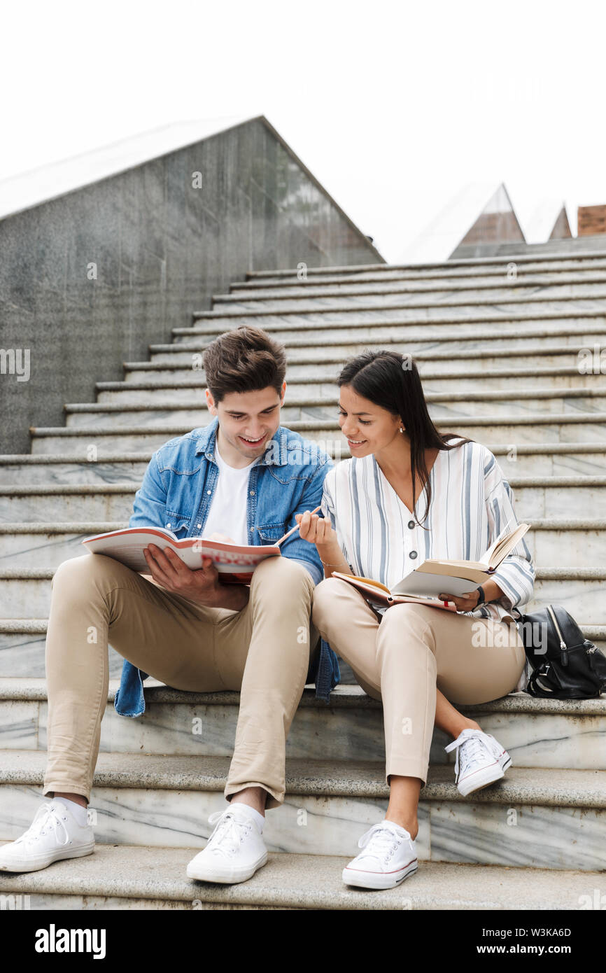 Photo of young amazing loving couple students colleagues outdoors ...