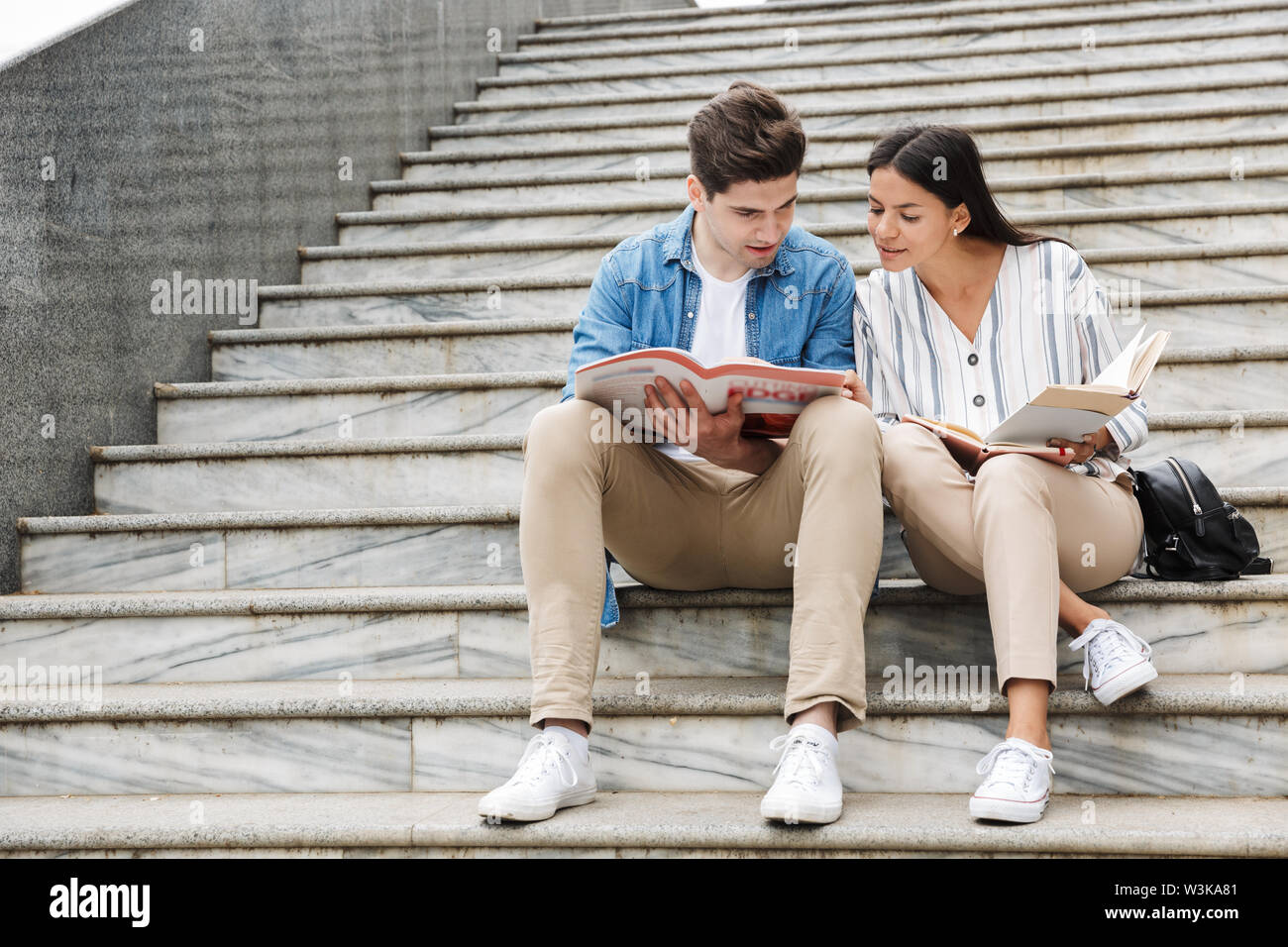 Photo of young amazing concentrated loving couple students colleagues ...