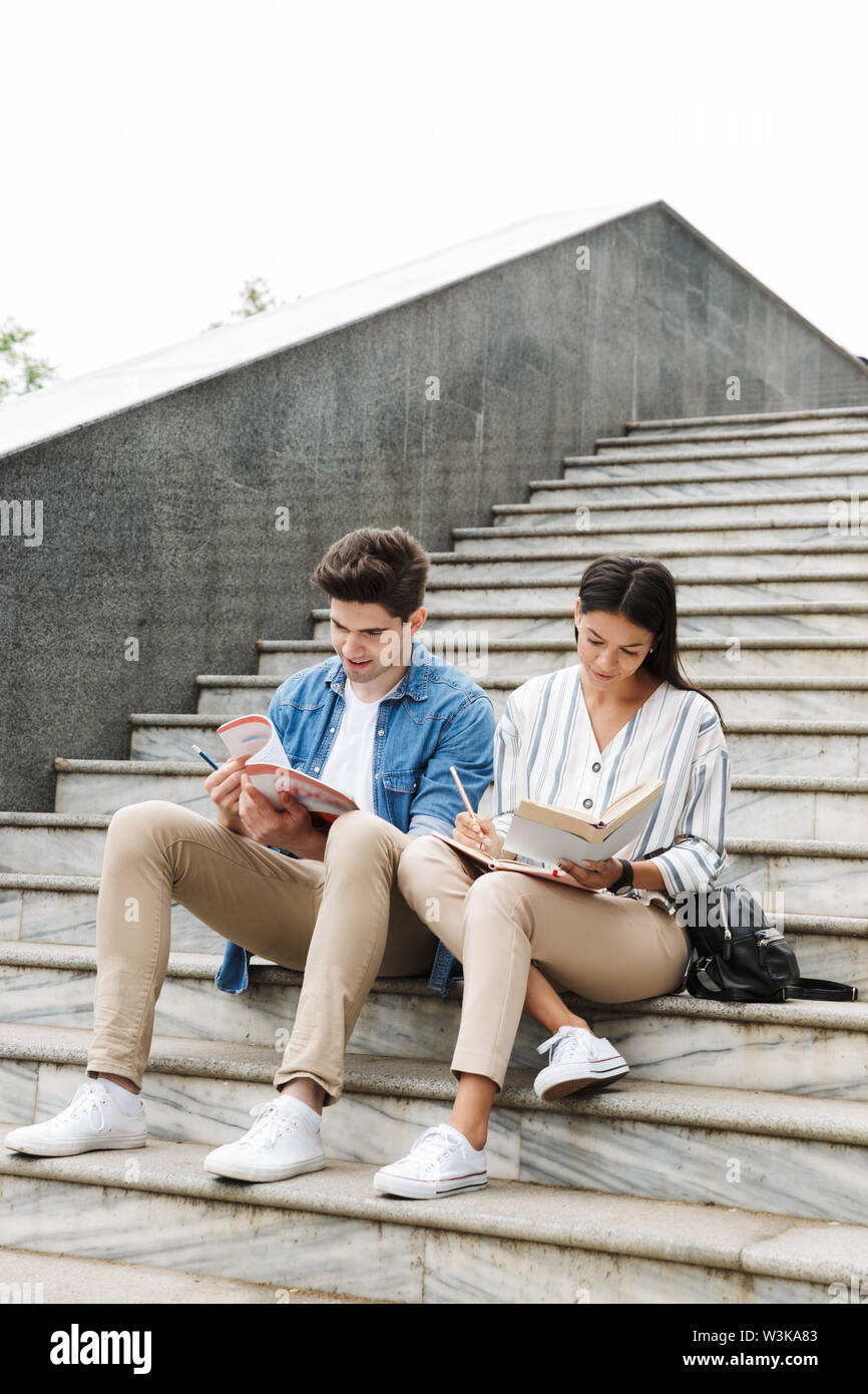 Photo of young amazing concentrated loving couple students colleagues ...