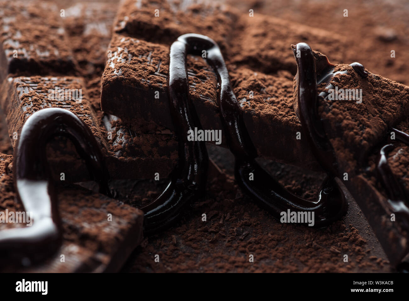 Close up view of chocolate with spilled liquid chocolate ad cocoa ...