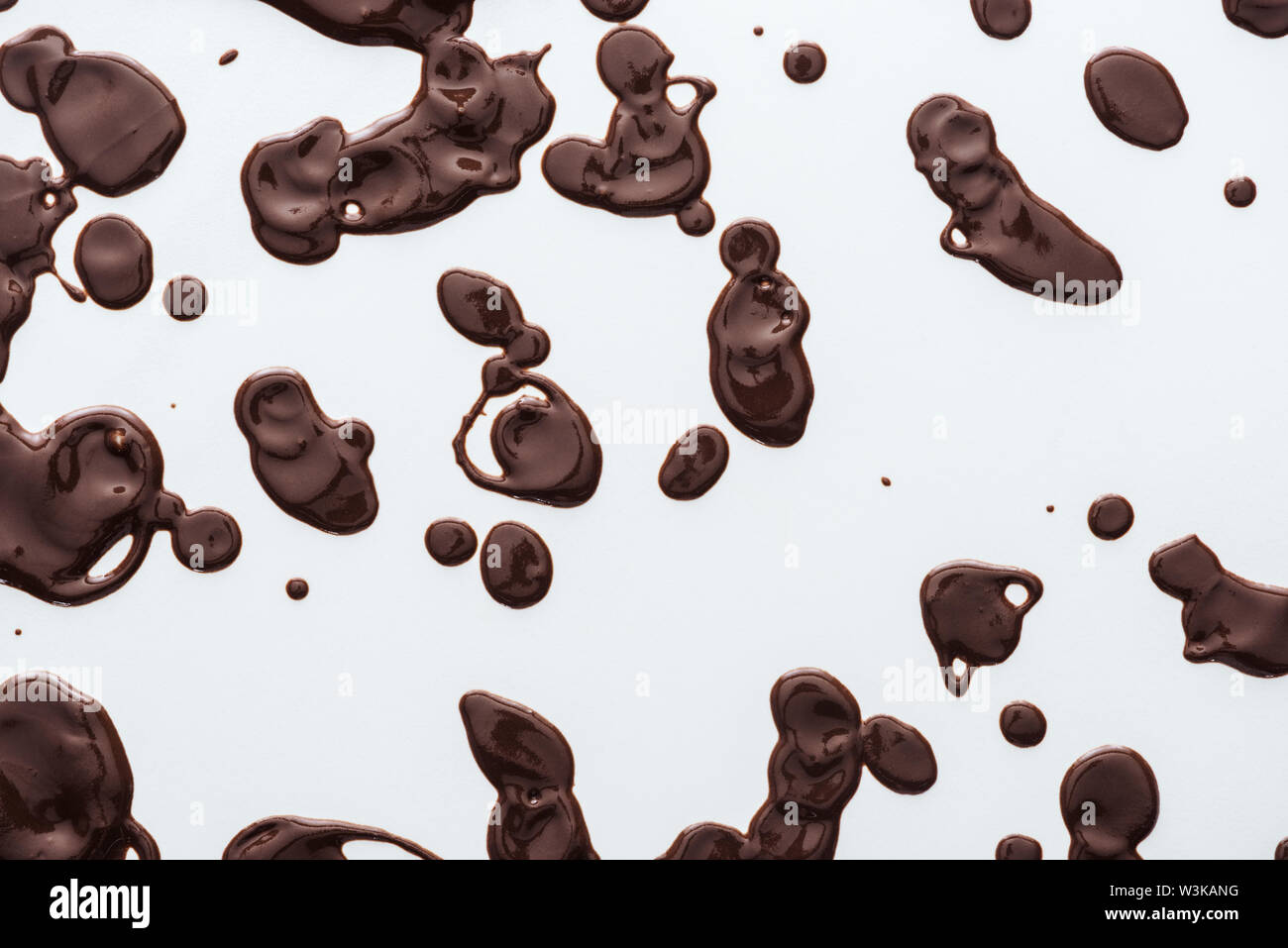 Top view of drops of liquid dark chocolate on white background Stock ...