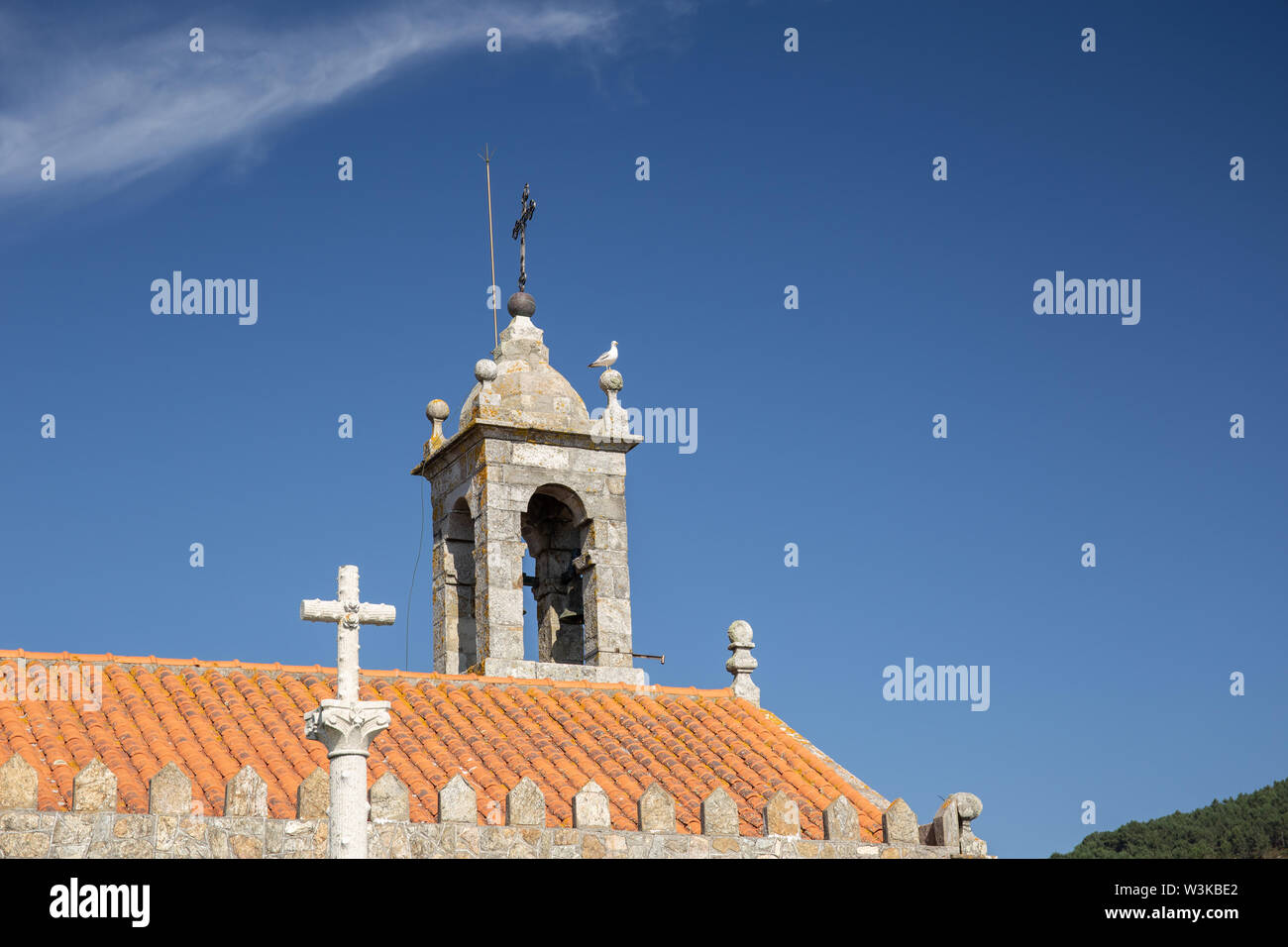View of a bell tower of a small catholic church building made of ...