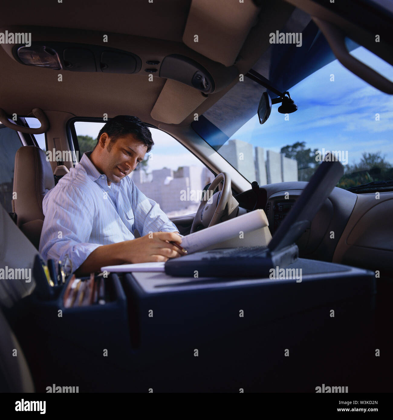 Businessman working in his car Stock Photo - Alamy