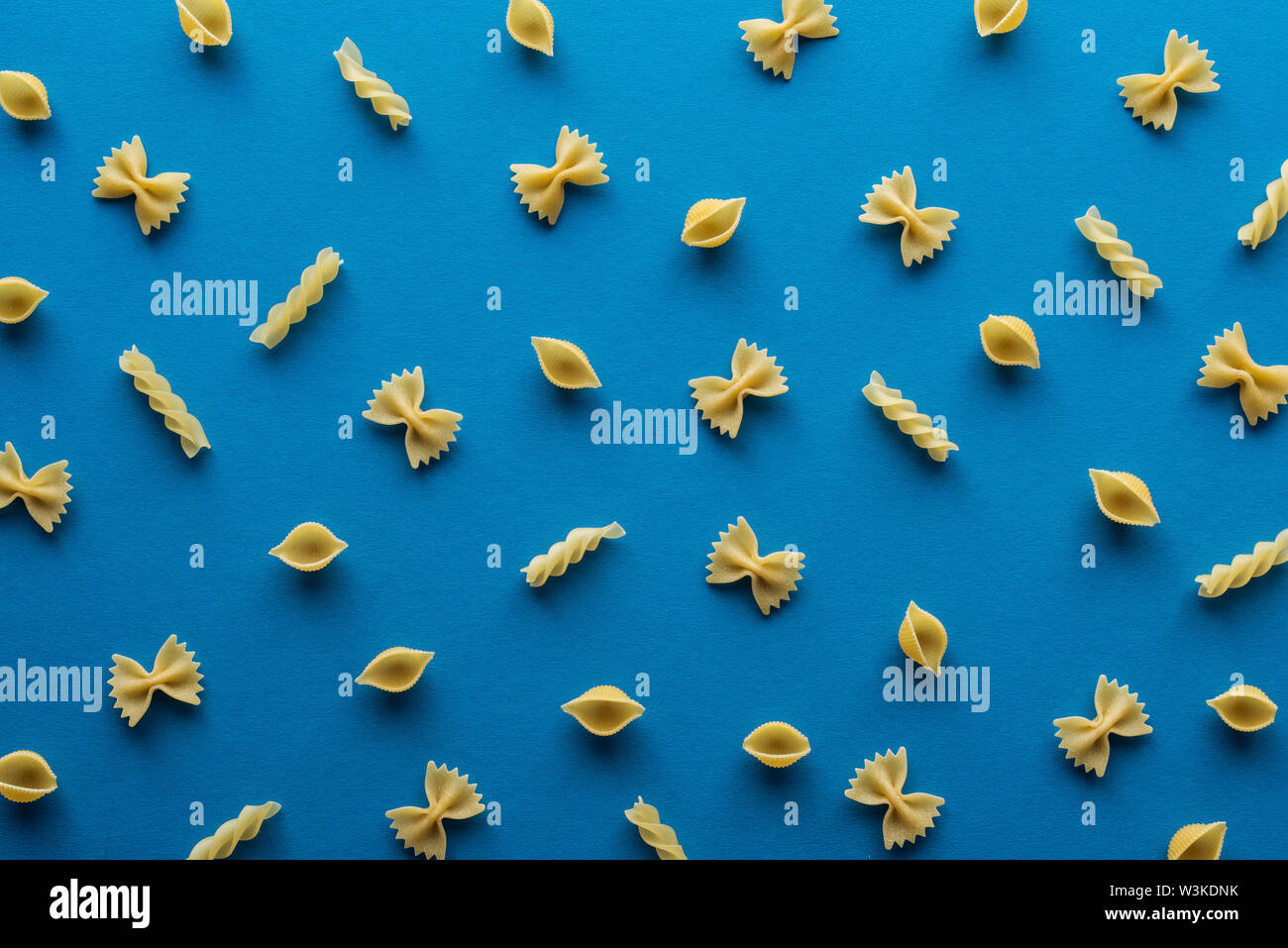 Uncooked pasta on blue hi-res stock photography and images - Alamy