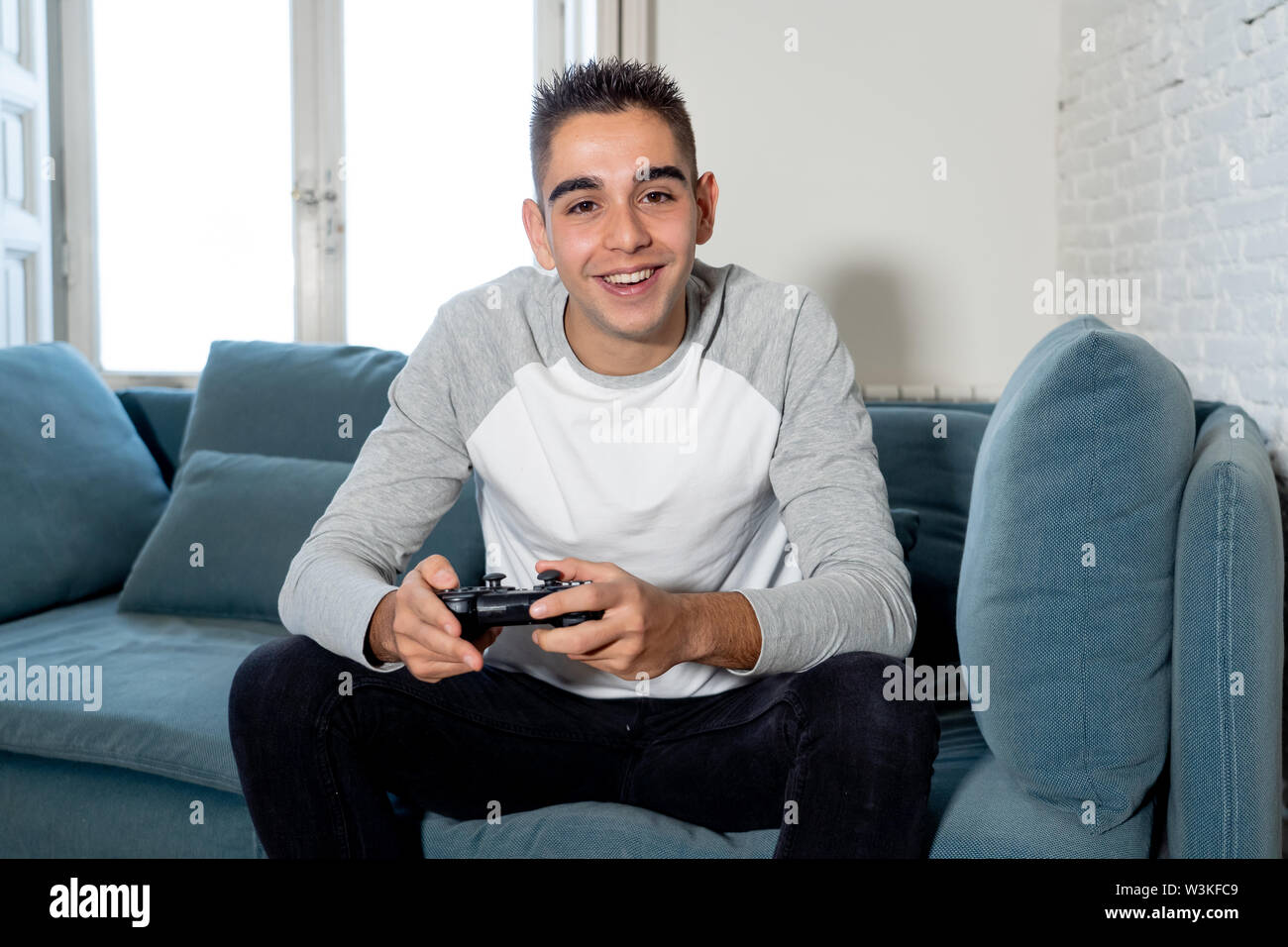 Portrait of young student man playing video games having fun winning ...