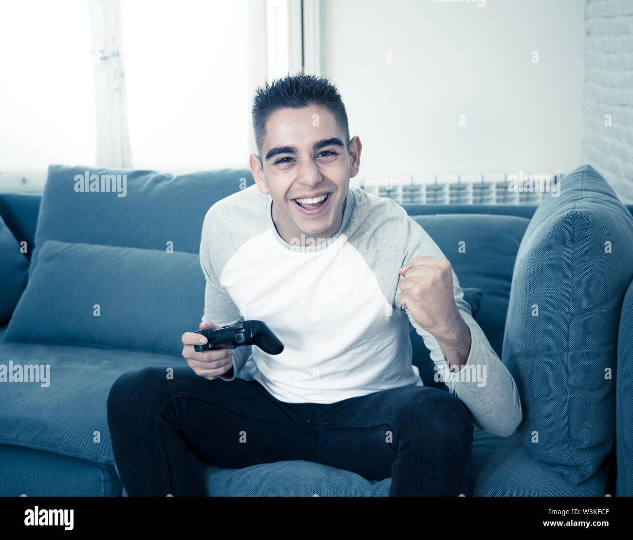 Portrait of young student man playing video games having fun winning ...