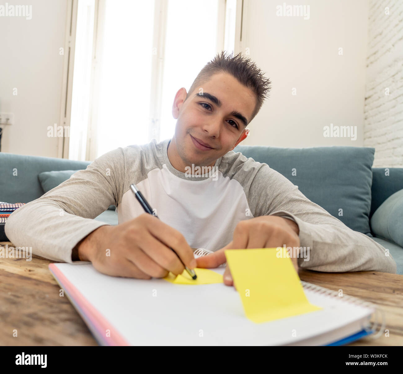 Portrait of happy young student man in his twenties working, studying ...