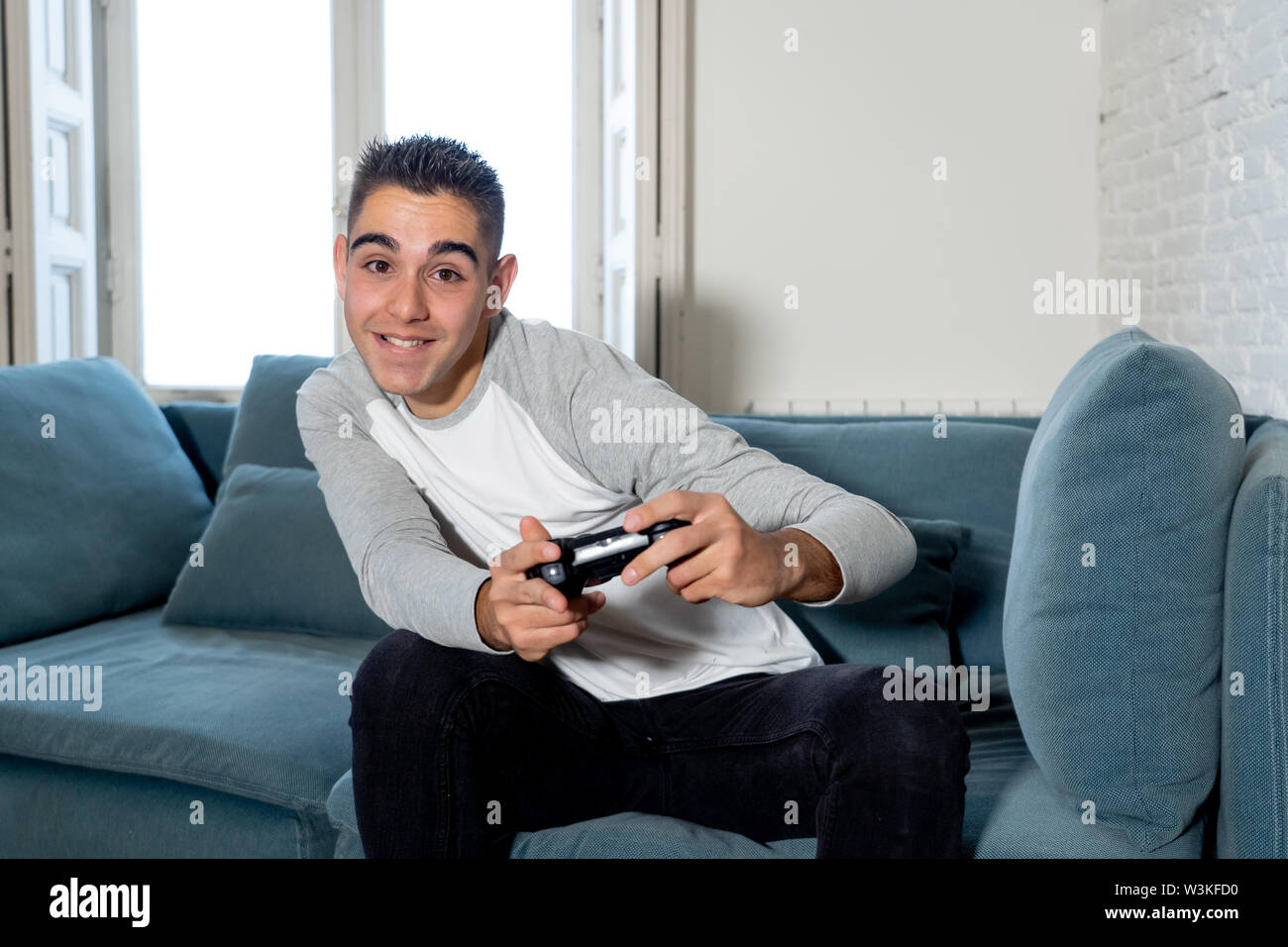 Portrait of young student man playing video games having fun winning ...