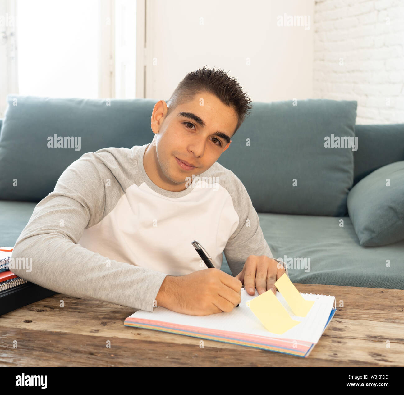 Portrait of happy young student man in his twenties working, studying ...