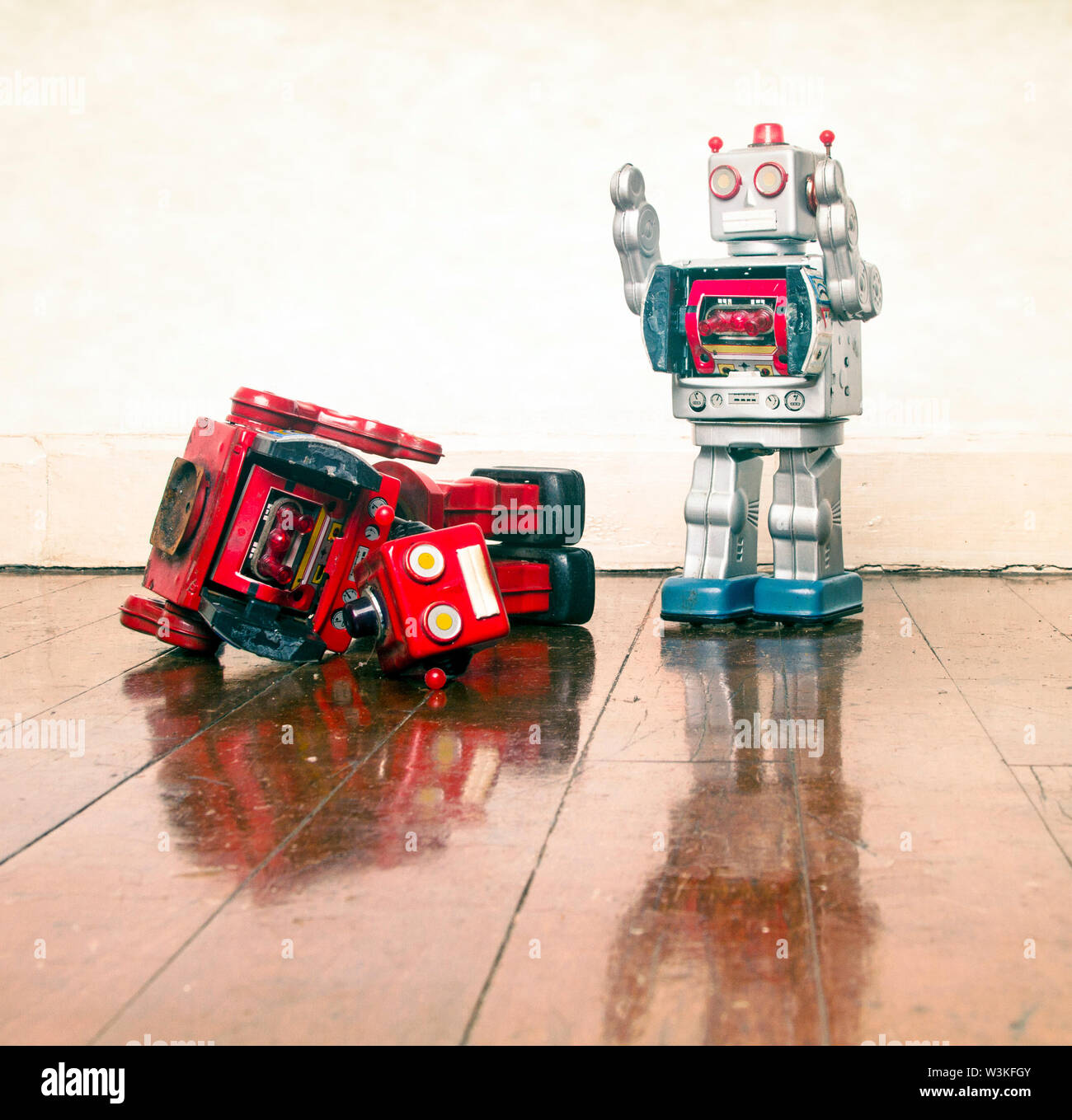 robot wars red robot defeated on old wooden floor Stock Photo - Alamy