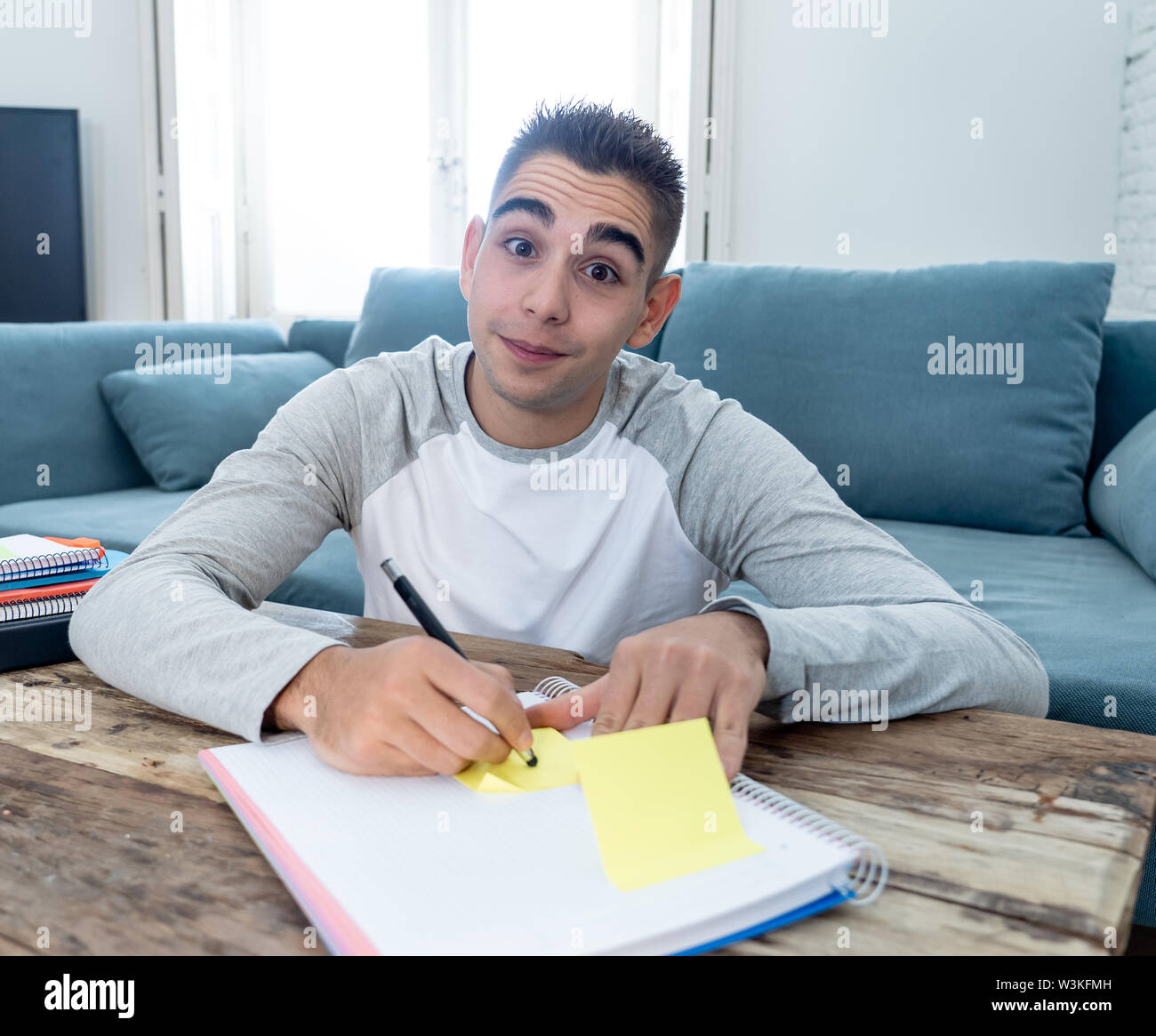 Overworked and tired university or high school male student working and ...