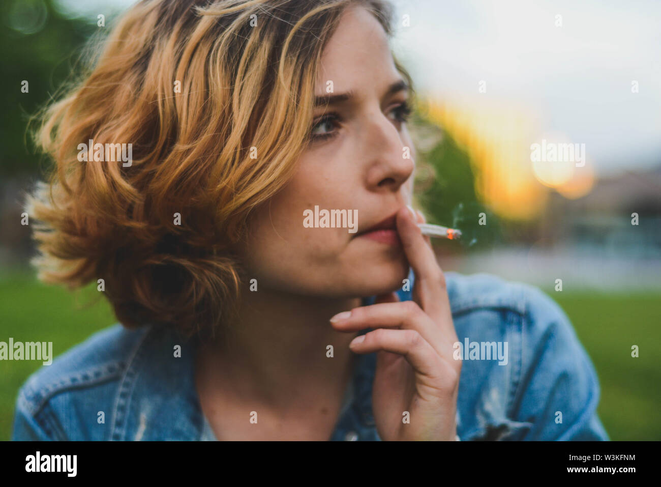 Lady smoking a cigarette hi-res stock photography and images - Alamy