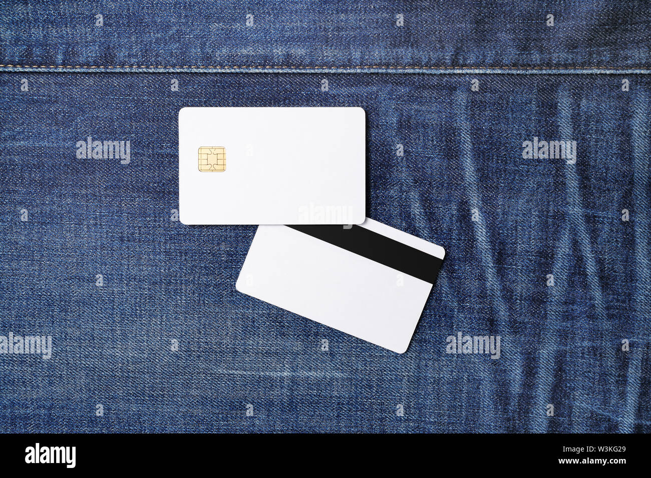 Two blank credit cards on denim background. Chip cards. Mockup for ...