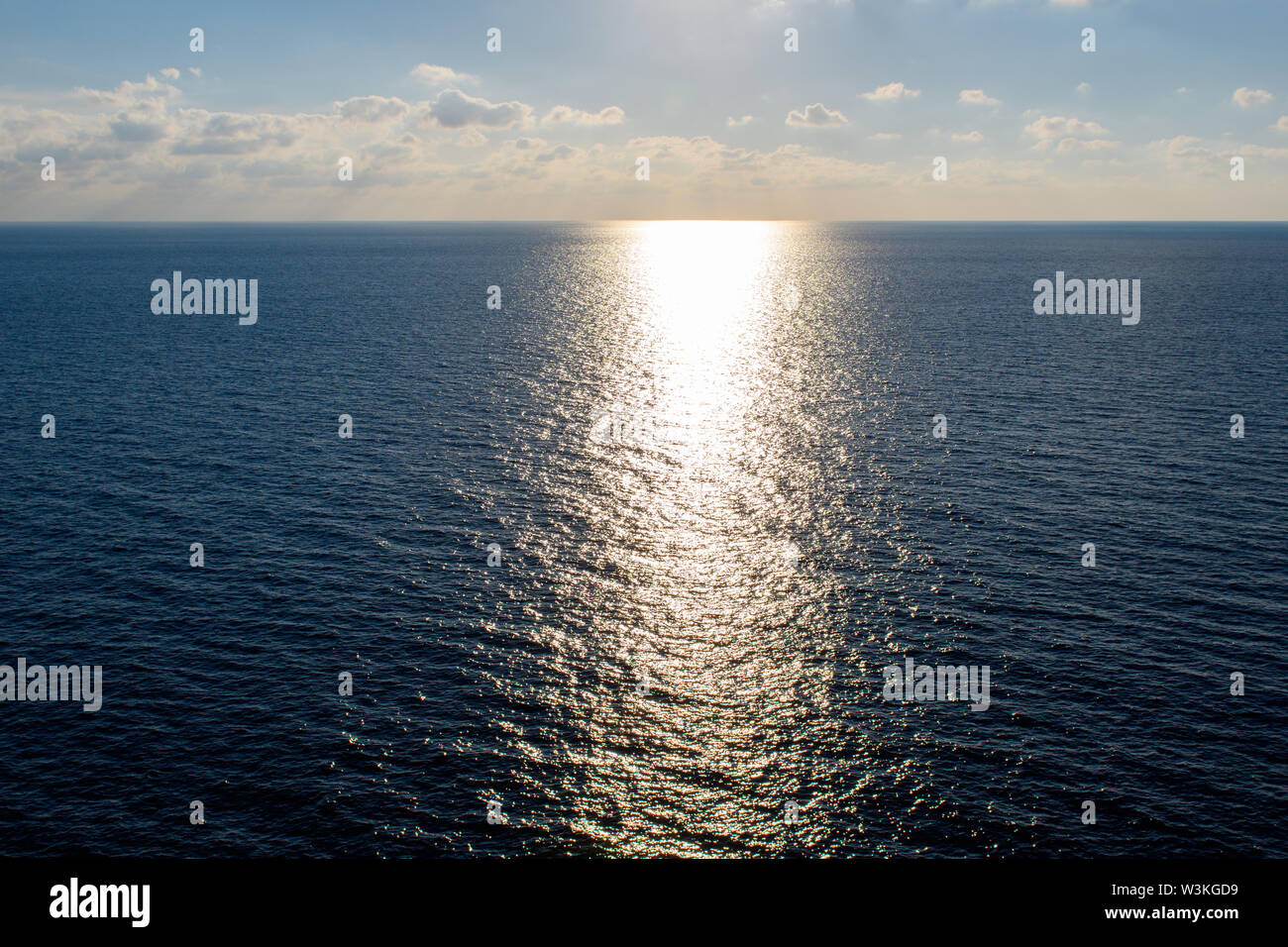 Blue Atlantic ocean to the horizon. Sunset sun with a path on the water ...