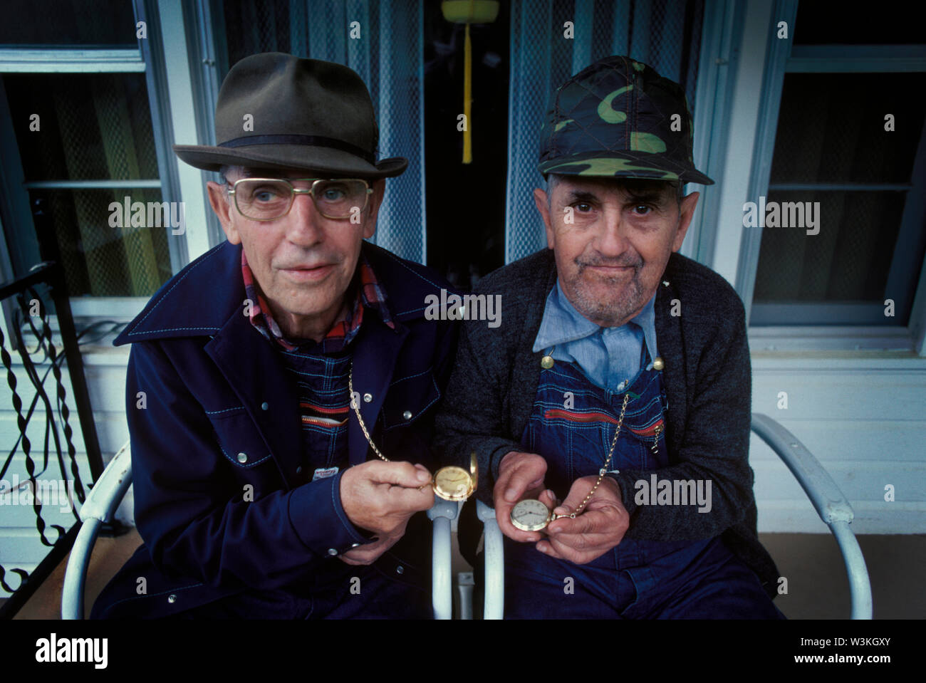 Two old men are showing their clocks to the camera Stock Photo - Alamy