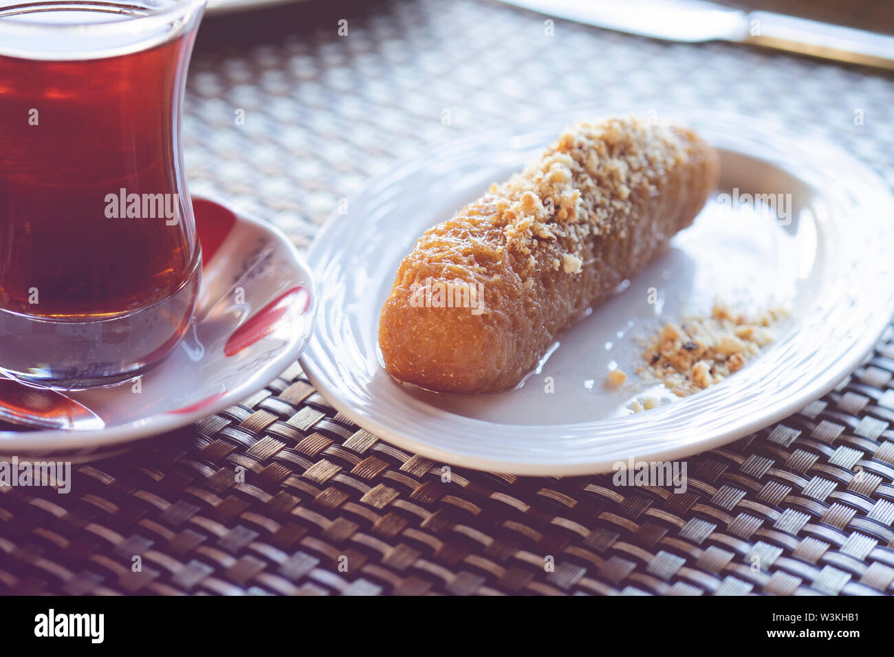 Turkish dessert from Erzurum dolma kadayifi and turkish tea. Close up ...