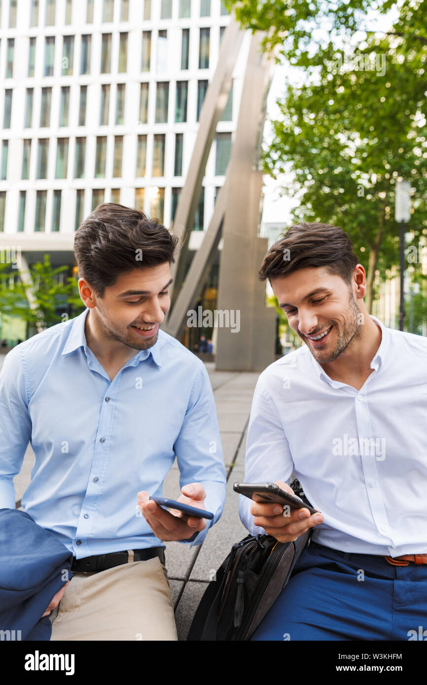 Image of a laughing cheerful happy young two friends colleagues ...