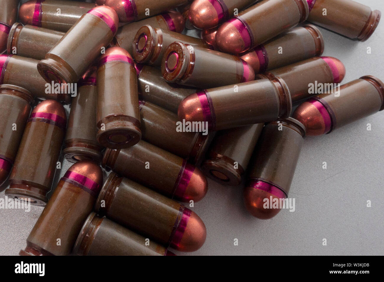 Cartridges bulk close up images. Bullets in shells for gun are piled ...