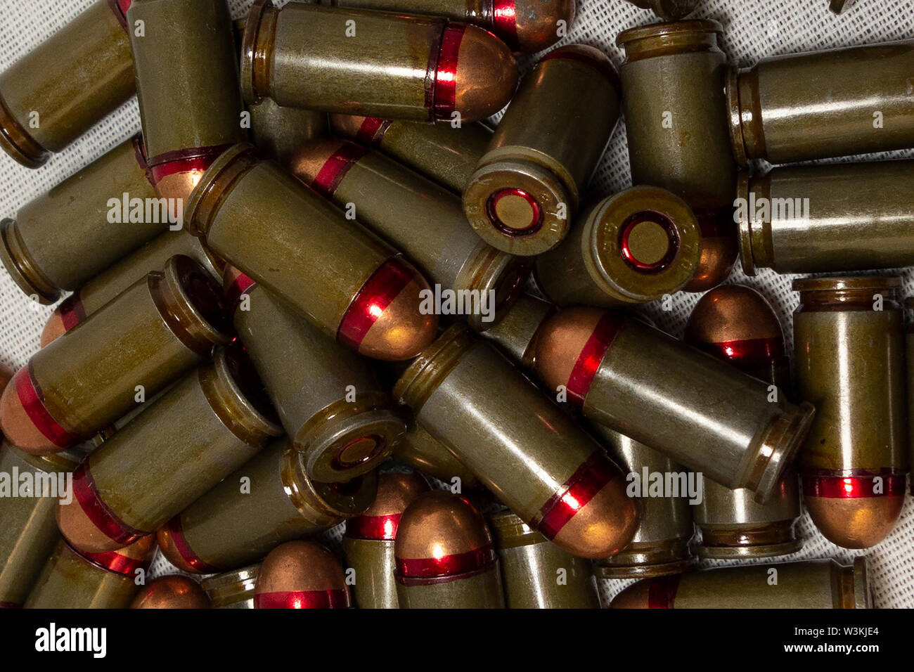 Cartridges bulk close up images. Bullets in shells for gun are piled ...