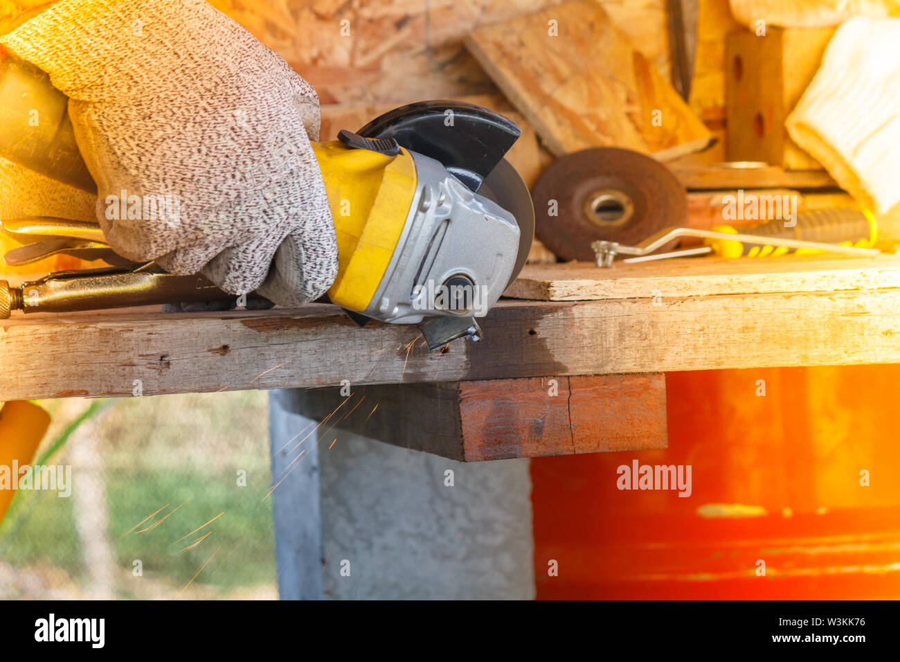 Sparks flying over the working during metal grinding Stock Photo - Alamy