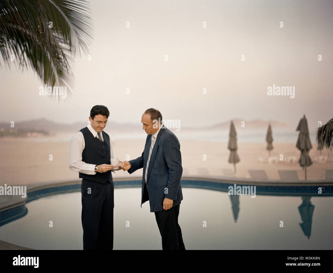 Two businessmen have a conversation near the swimming pool Stock Photo ...