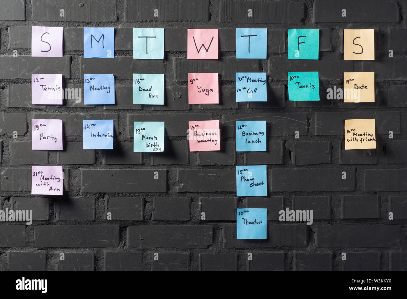 colorful sticker notes on black brick wall Stock Photo - Alamy