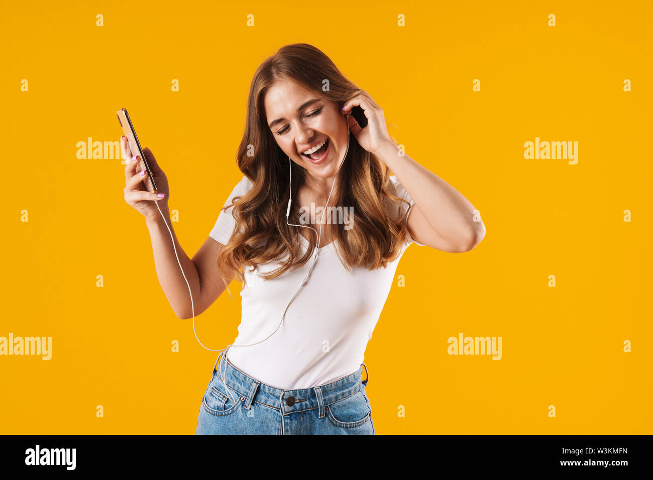 Image of joyful caucasian woman wearing basic t-shirt singing while ...