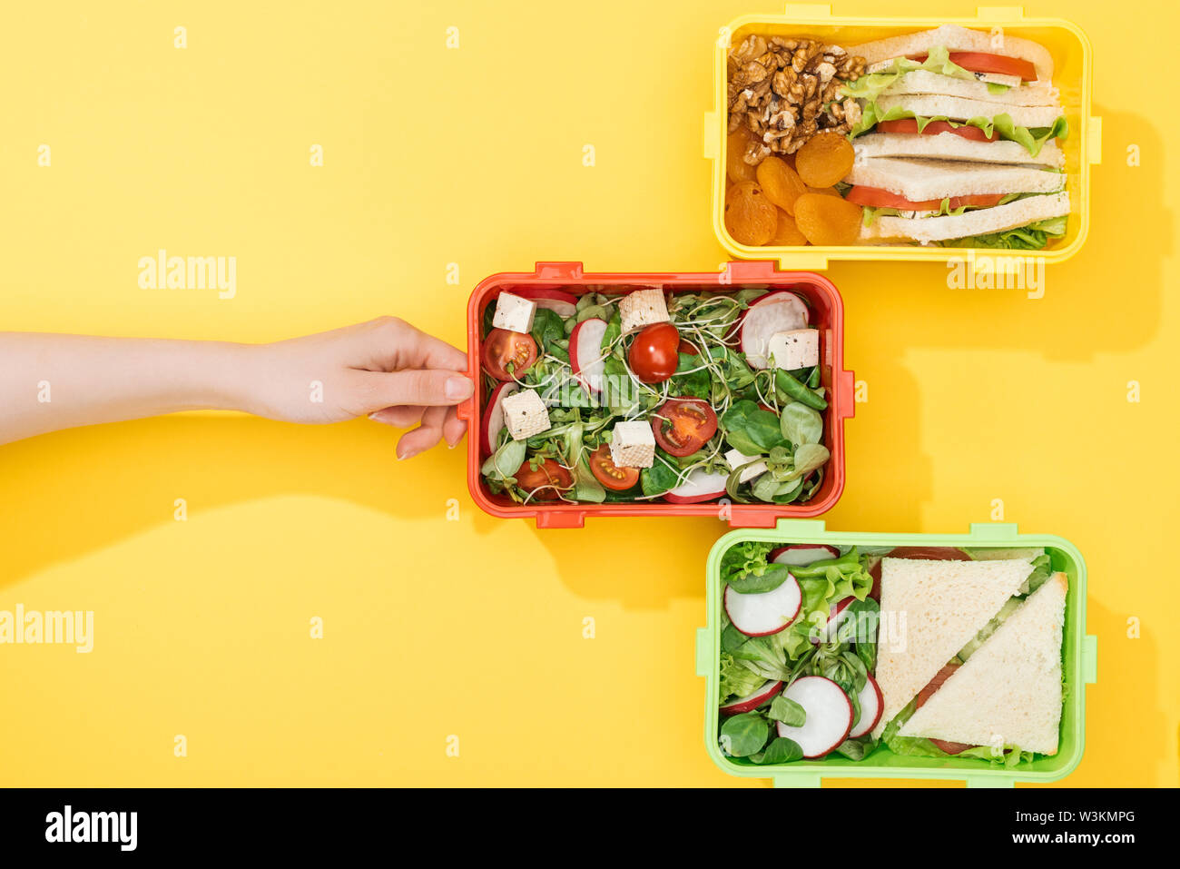 cropped view of woman choosing lunch boxes with food Stock Photo - Alamy