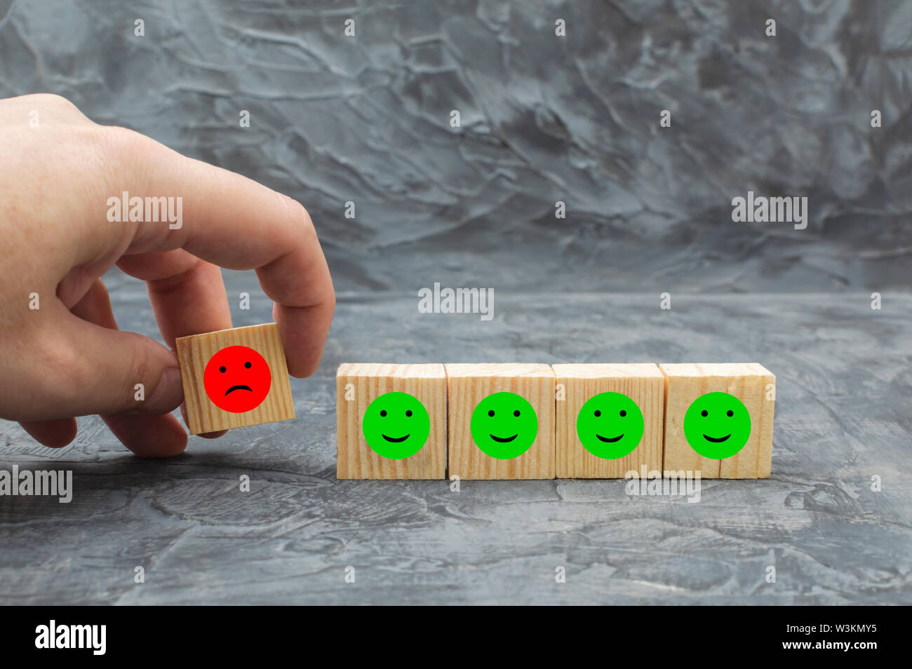 Wooden block with icon face emotion happiness and sadness. Individual ...