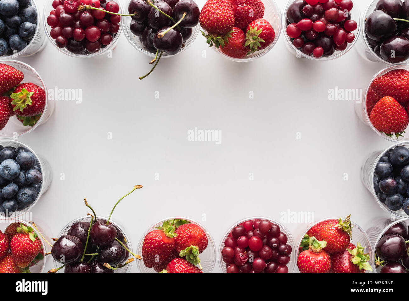 top view of whole cranberries, strawberries, blueberries and cherries ...