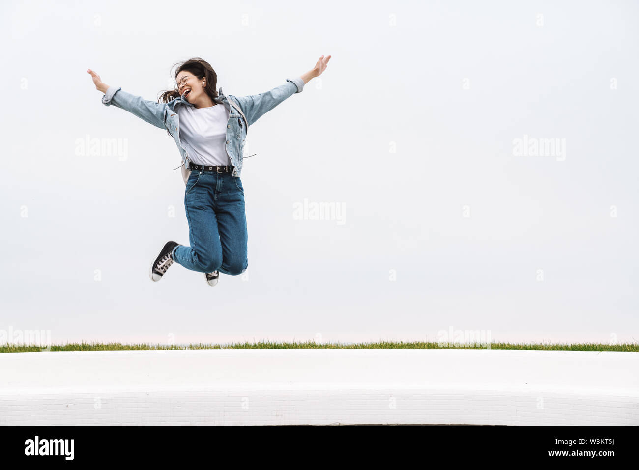 Girl walking along wall hi-res stock photography and images - Alamy