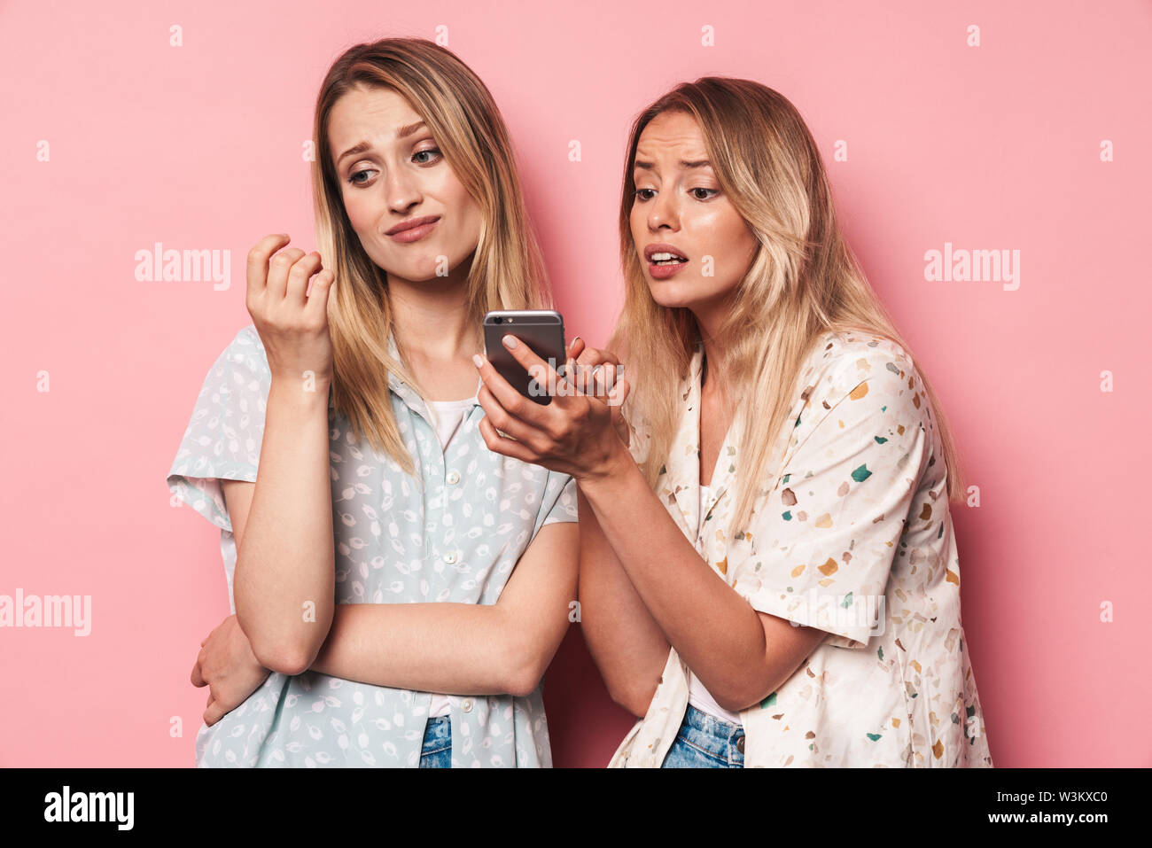 Picture of shocked girl using mobile phone showing display to her ...