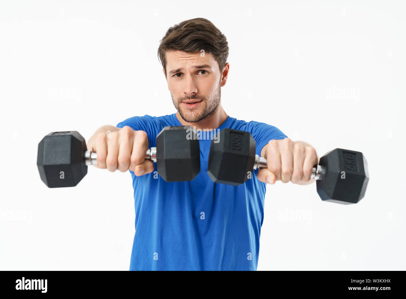 Image of tired handsome young sports fitness man standing isolated over ...