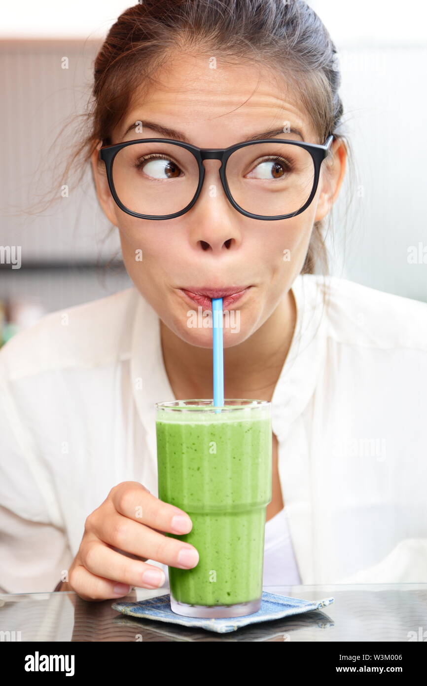 Green vegetable smoothie juice - woman hipster drinking smoothie as ...