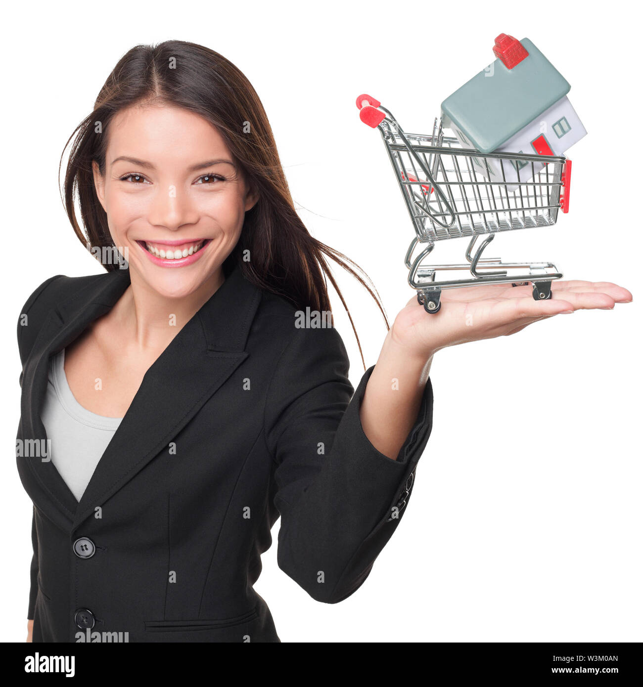 Real estate agent selling home holding mini house in shopping cart ...