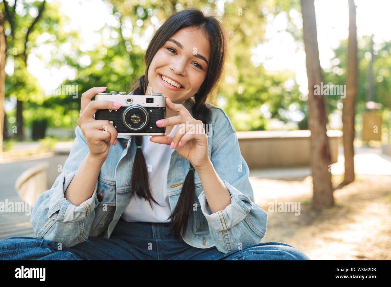 Photo of a cheerful optimistic cute young student girl wearing ...