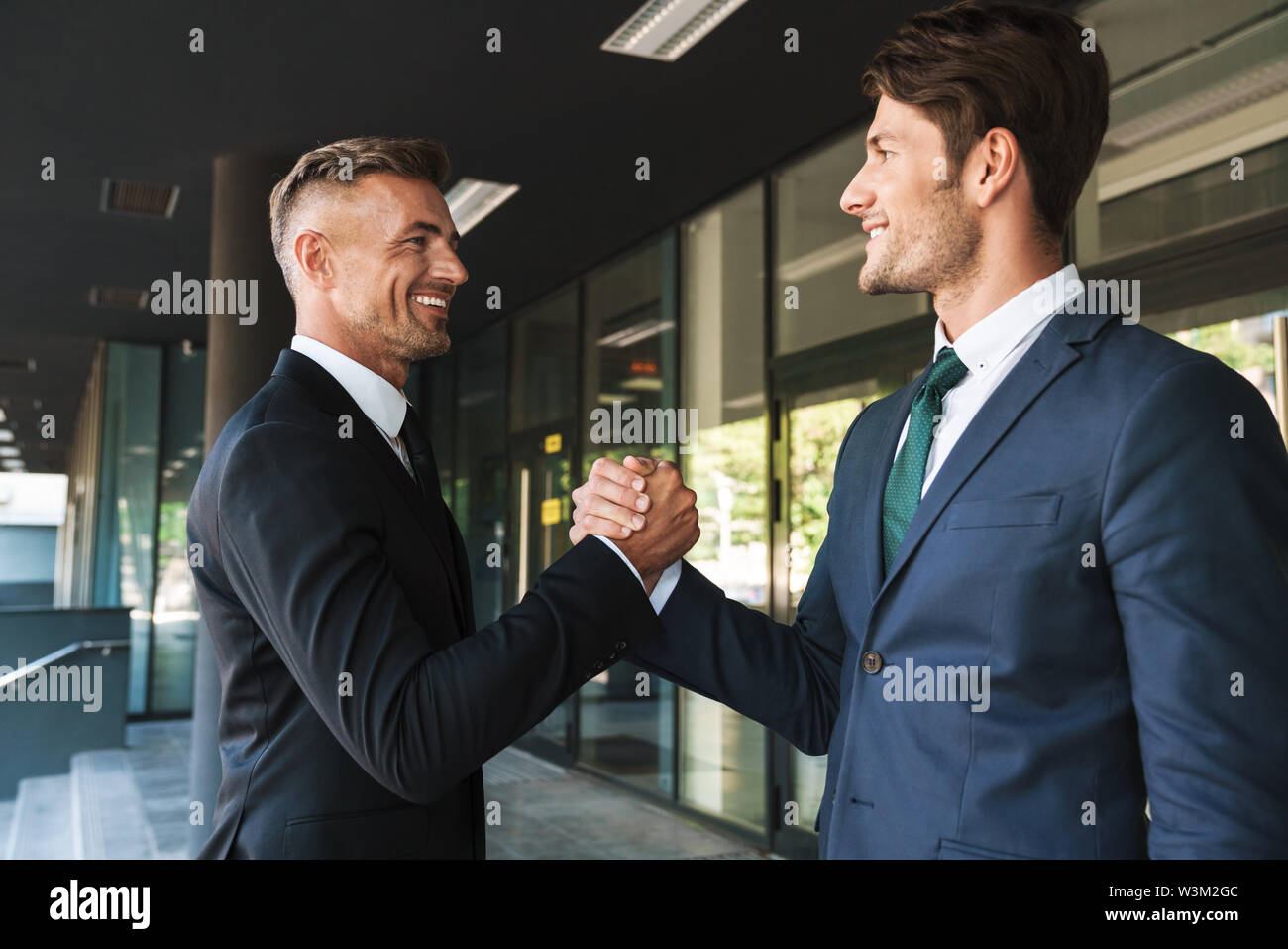 Portrait closeup of two handsome businessmen partners dressed in formal ...