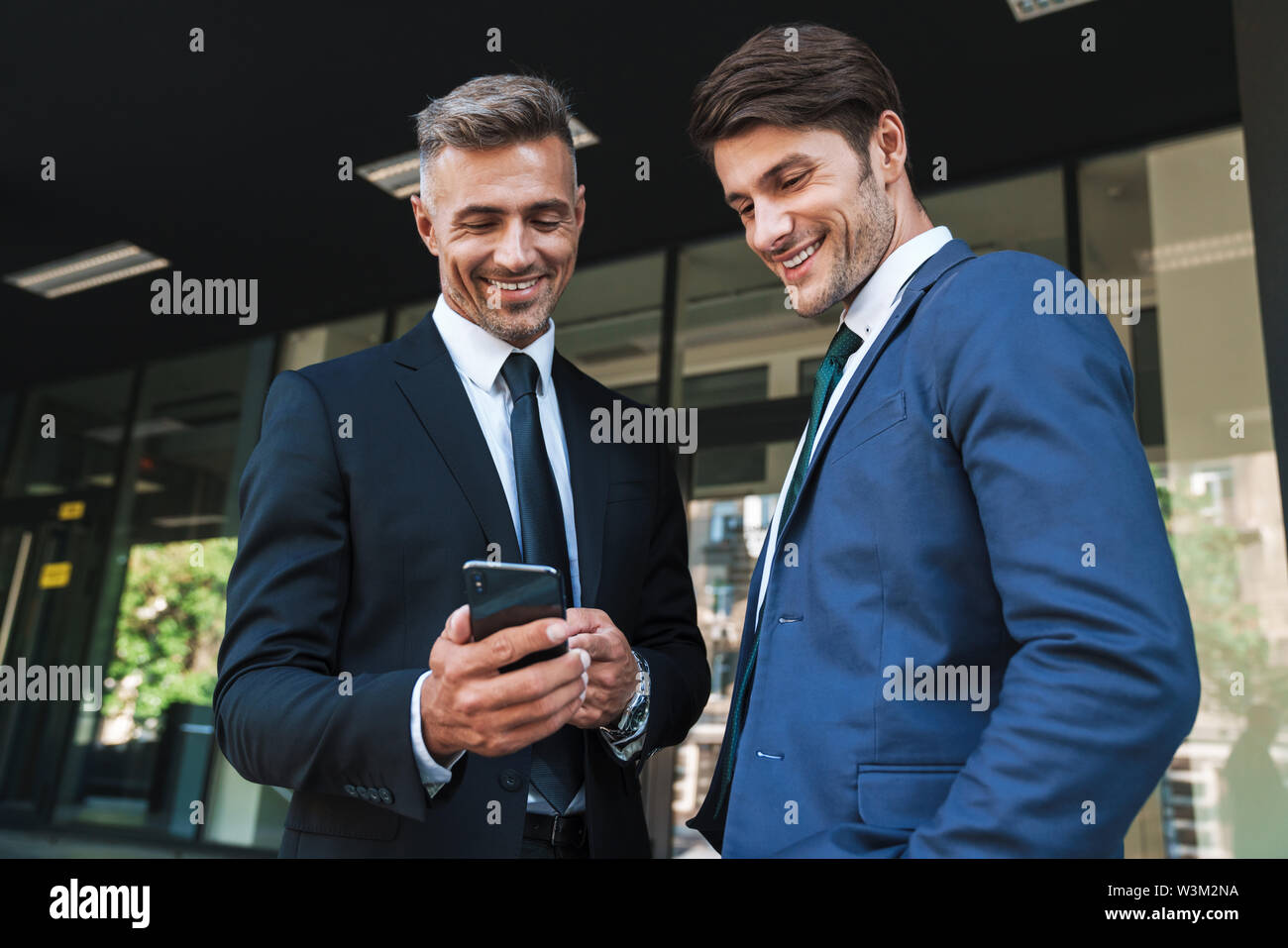 Portrait of successful businessmen partners dressed in formal suit ...