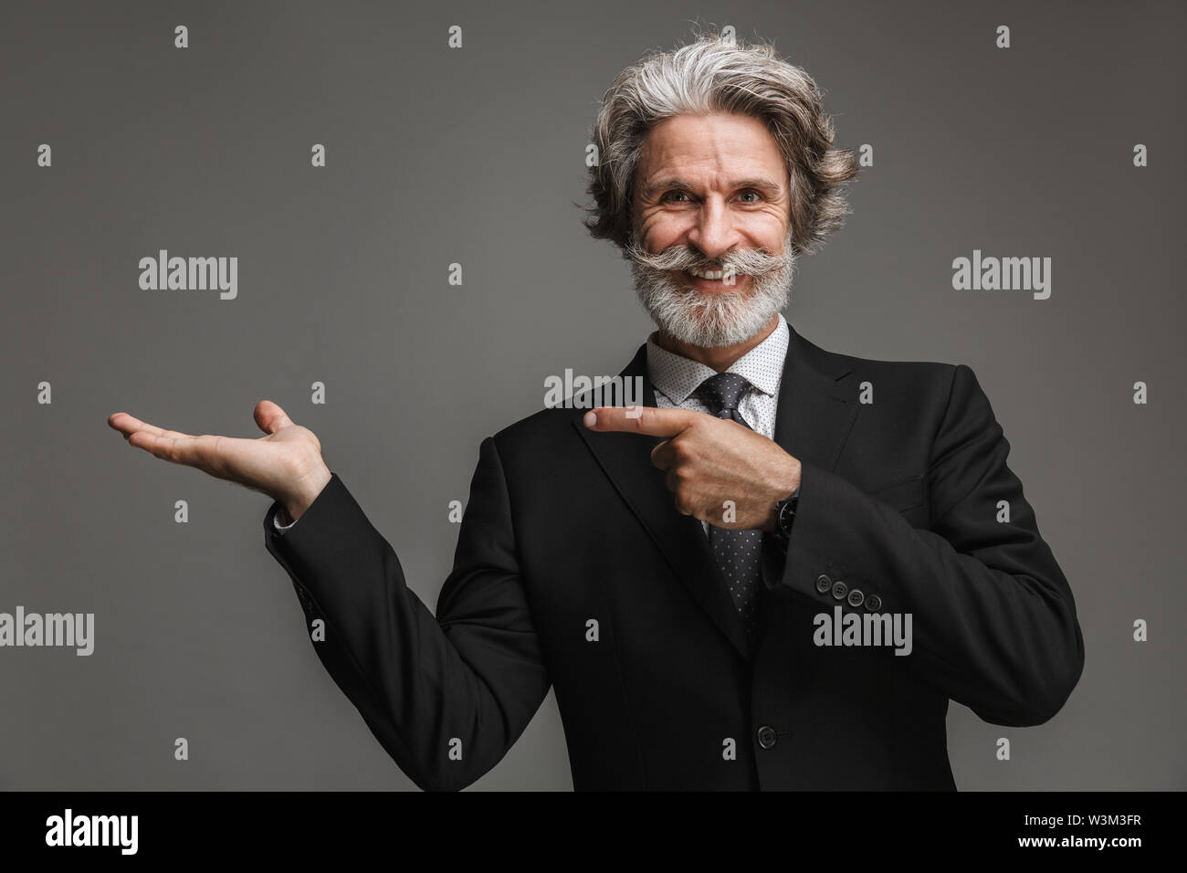 Image of happy adult businessman wearing formal black suit smiling and ...