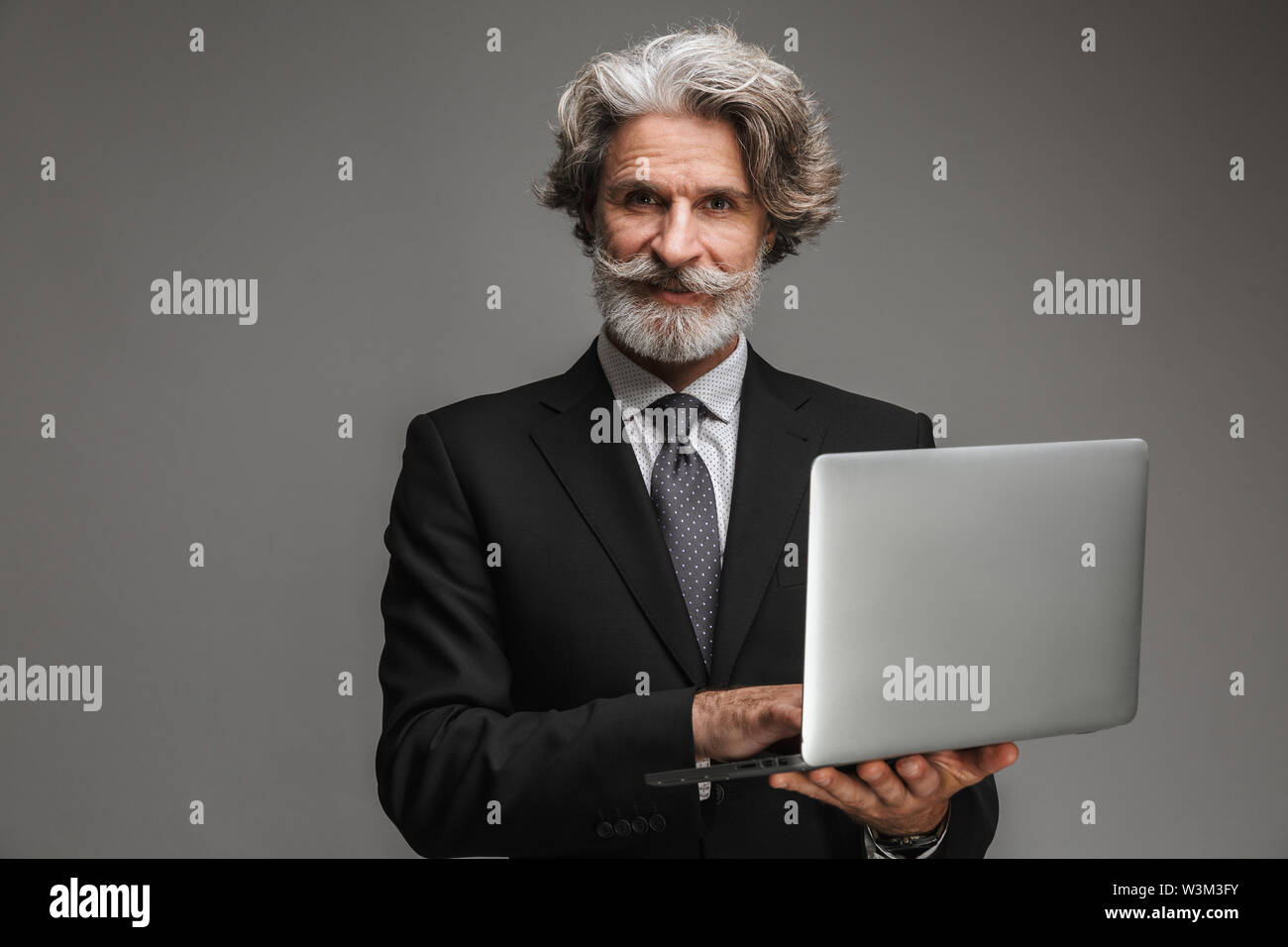 Image Of Unshaven Adult Businessman Wearing Formal Black Suit Holding
