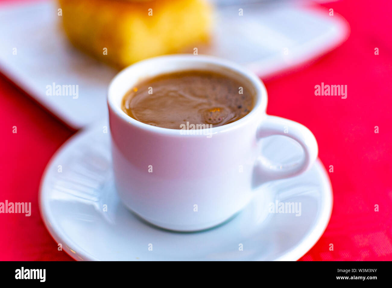 Traditional greek coffee served in white coffee set in cafe close up ...