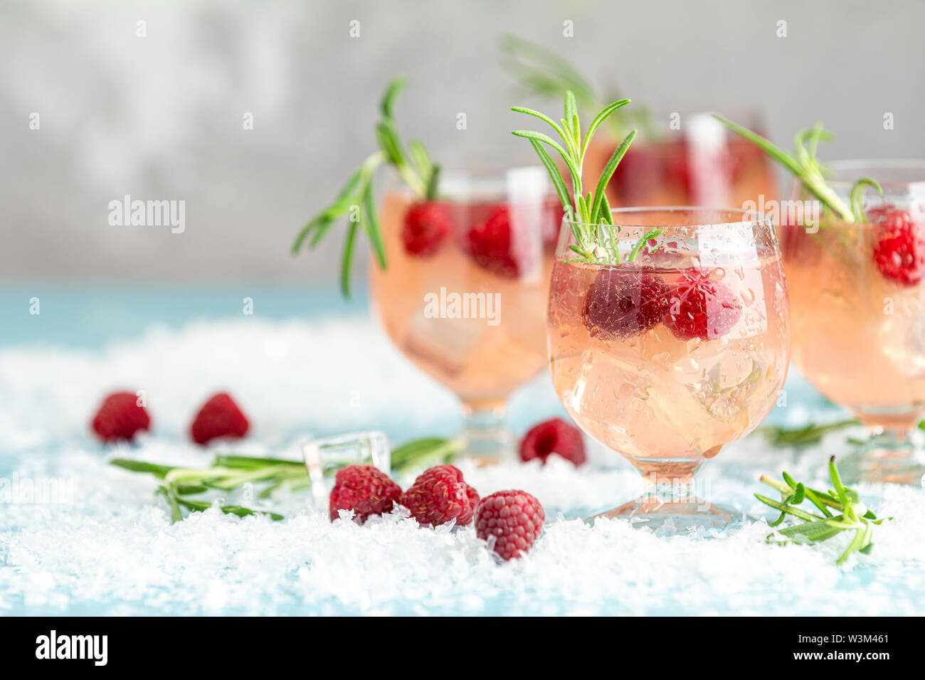 Christmas pink drink raspberry with rosemary and ice. Glasses with cold ...
