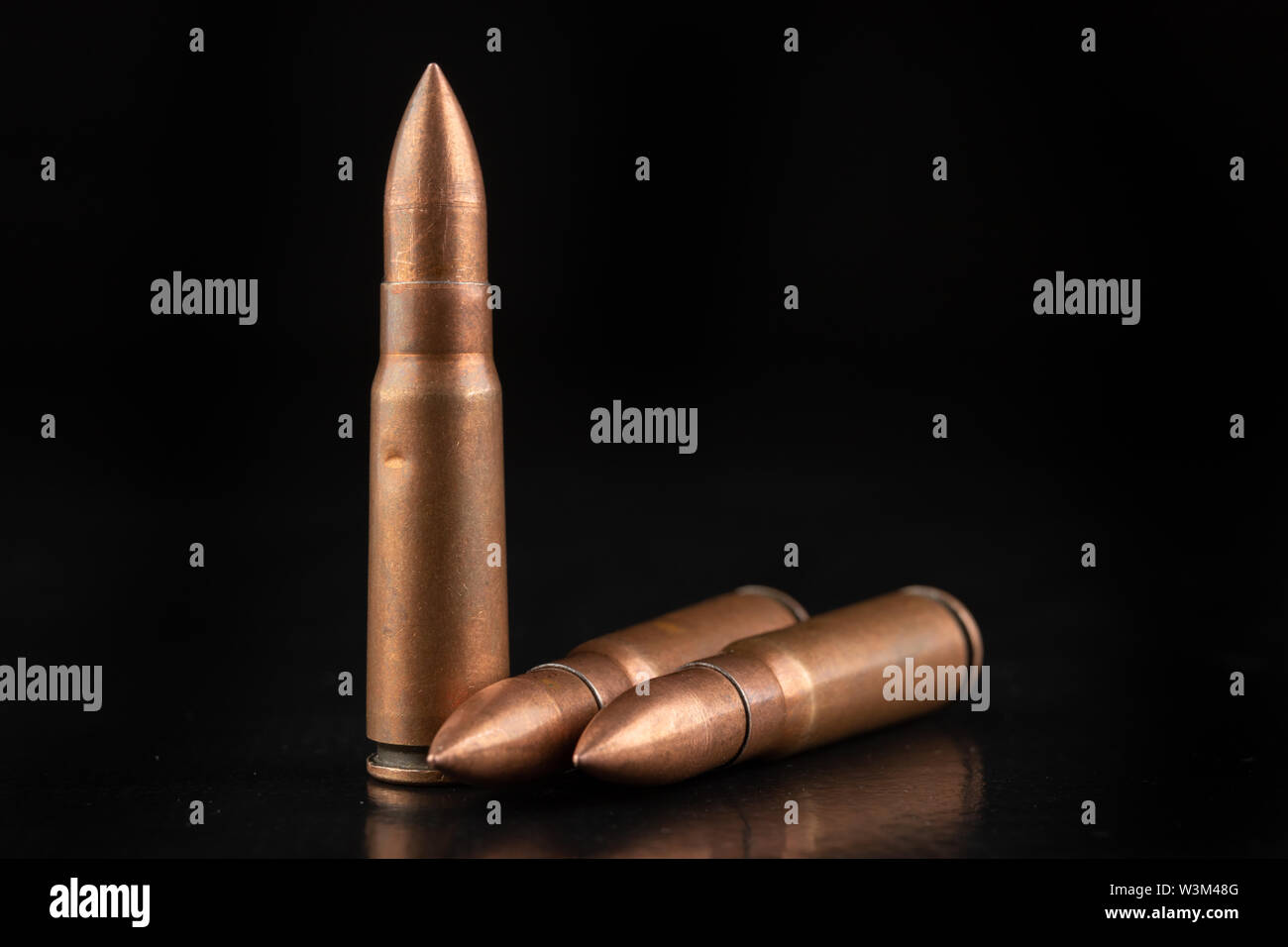 Ammunition of a high-speed rifle. Cartridges for a military rifle. Dark ...