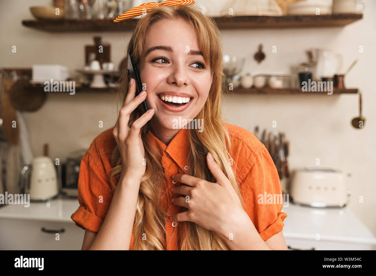 Picture of a pleased happy smiling young blonde girl chef cooking at ...