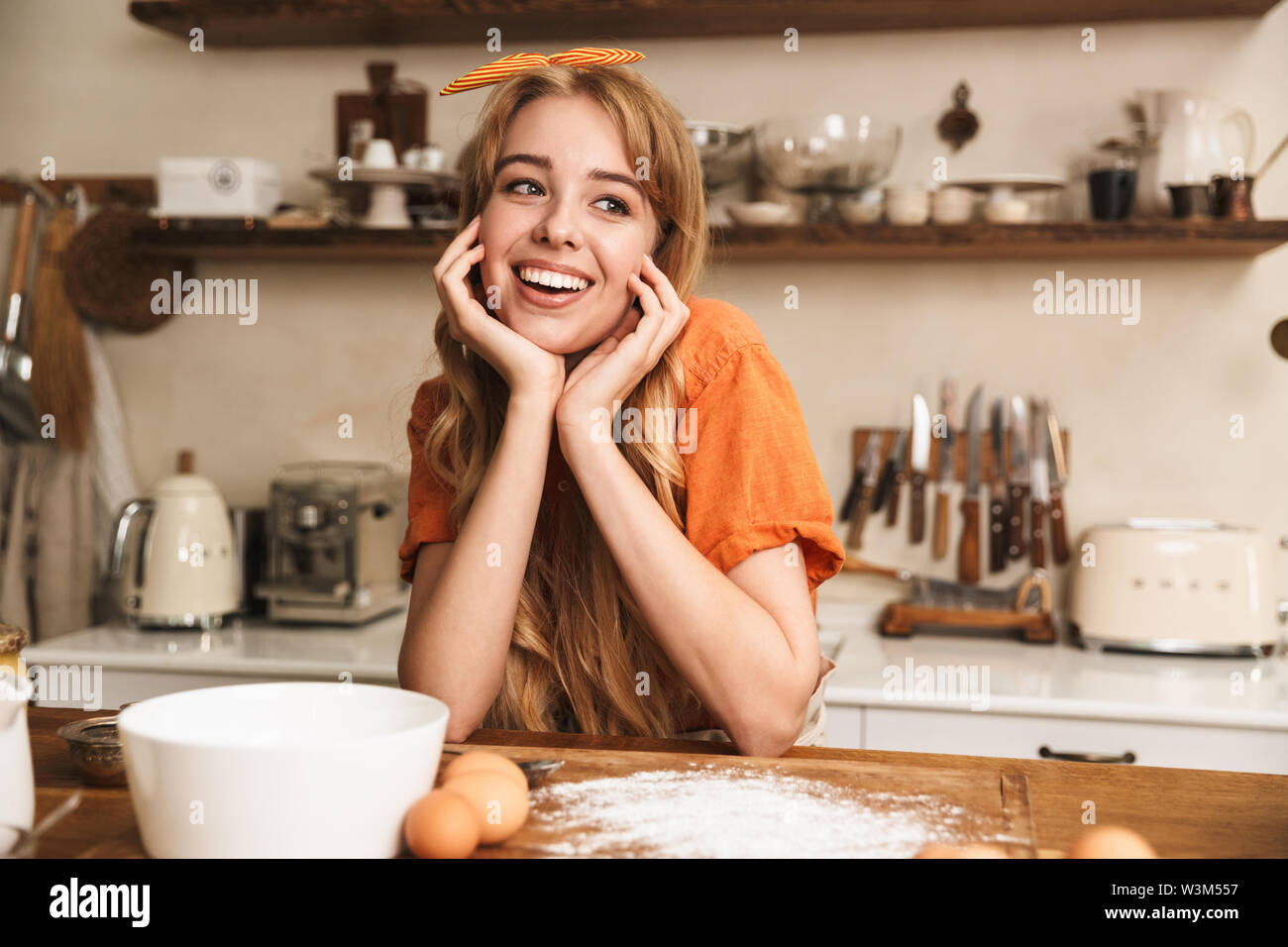 Picture of a happy cheerful smiling young blonde girl chef cooking at ...