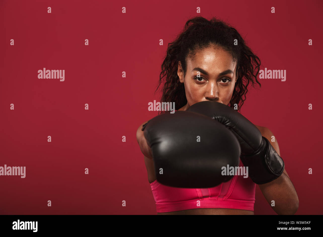 Image of a beautiful serious strong young african sports woman boxer ...