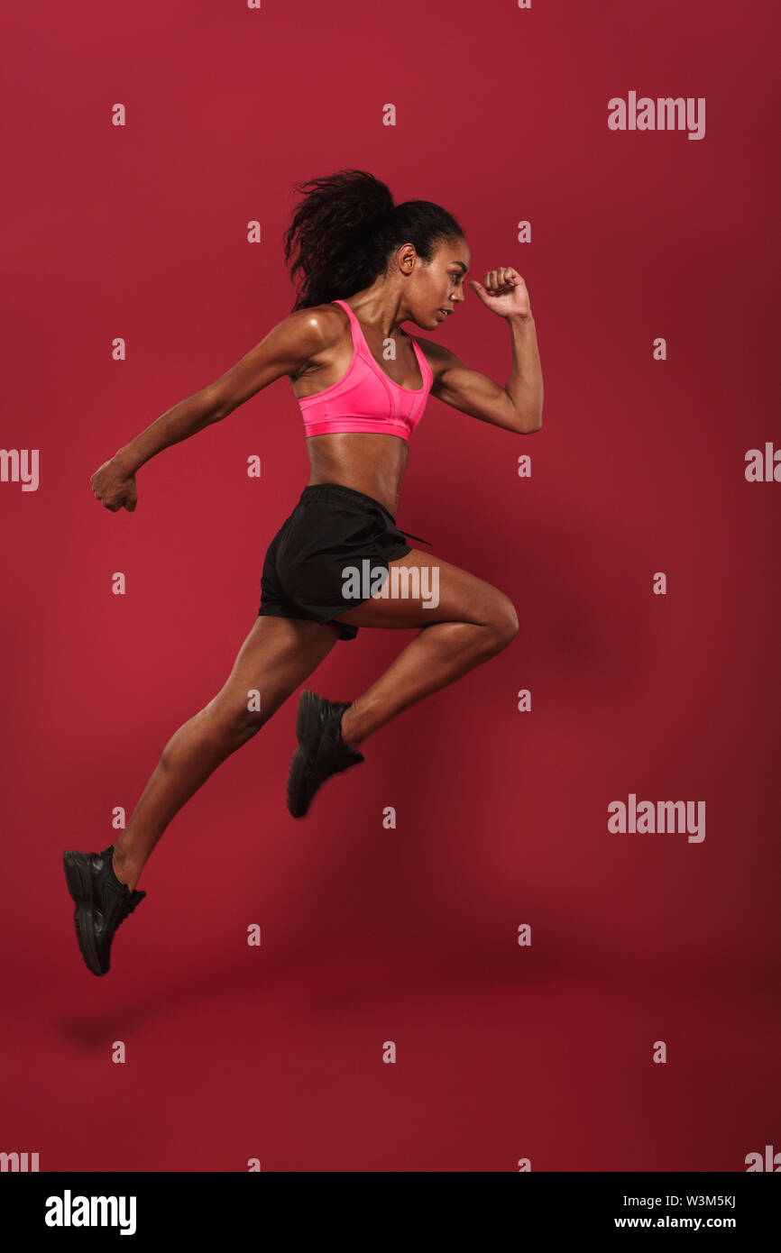 Image of a beautiful runner concentrated strong young african sports ...