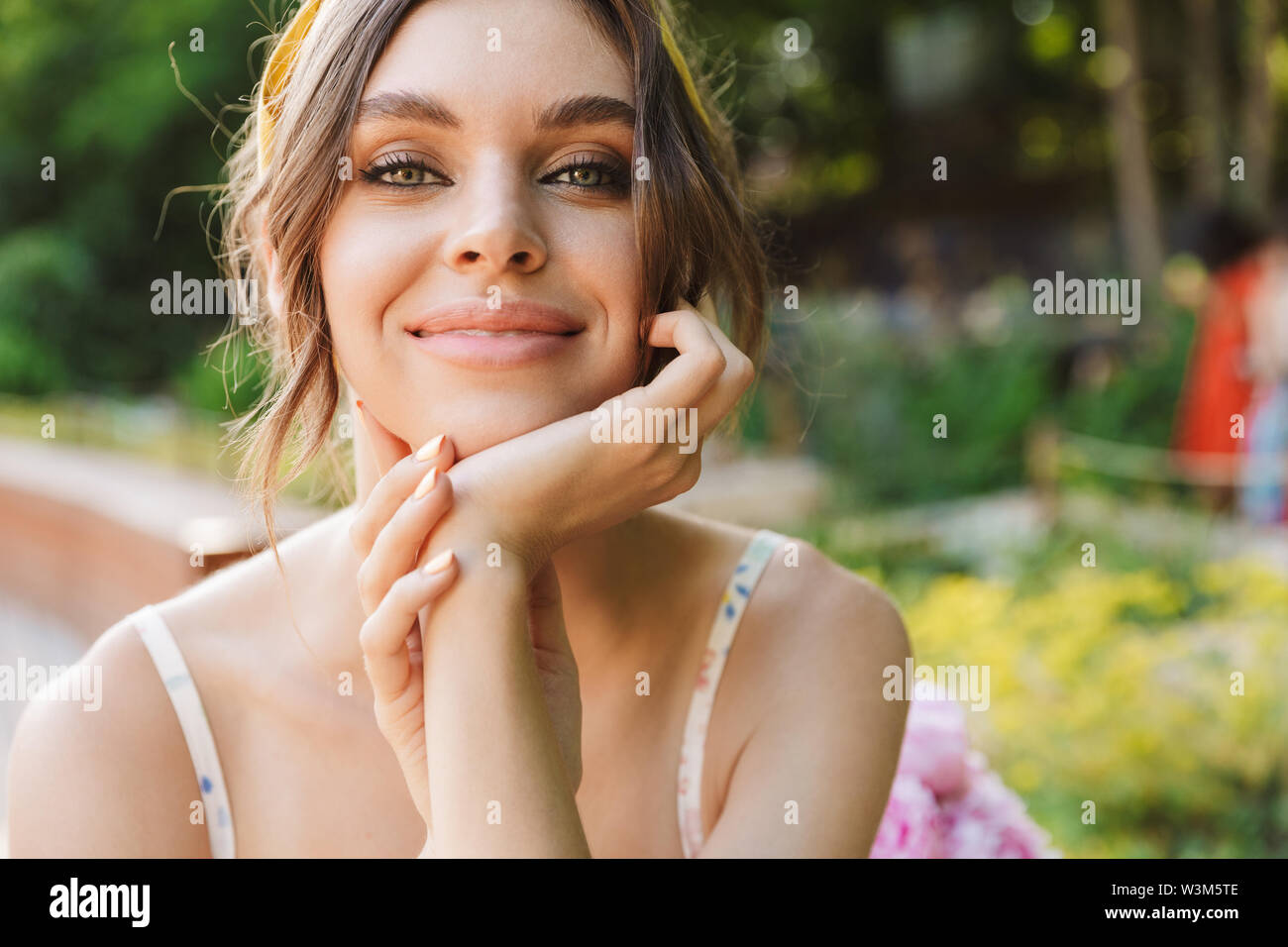 Photo of a smiling optimistic beautiful young pretty woman in green ...